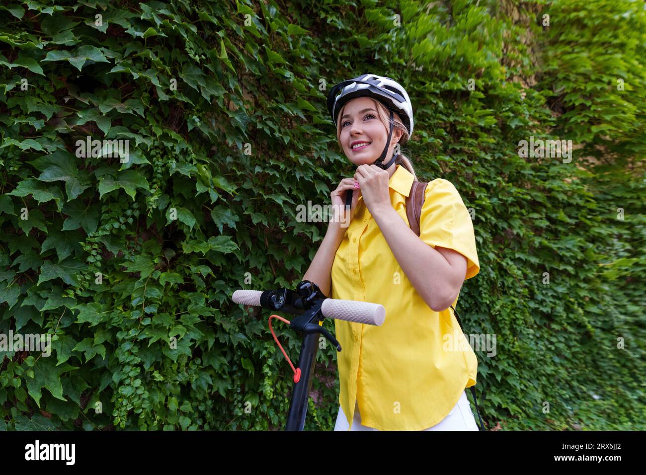 Young woman adjusting helmet hi-res stock photography and images - Alamy