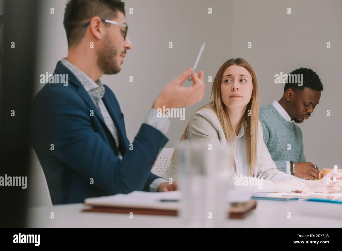 Close up of business man with dark blue suit explaining something to ...