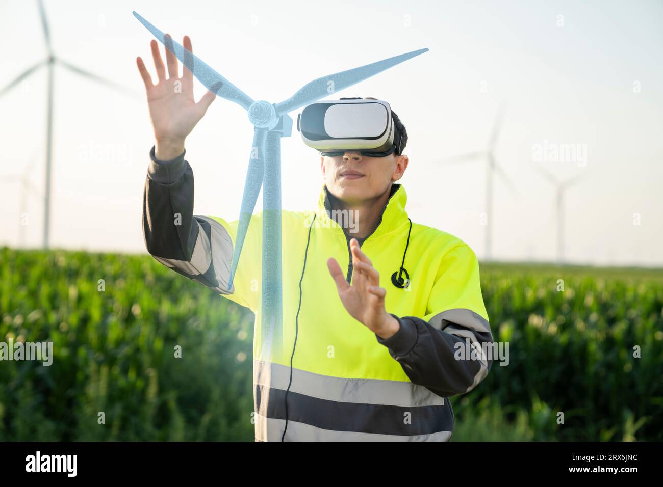Engineer examining augmented wind turbine model through virtual reality ...