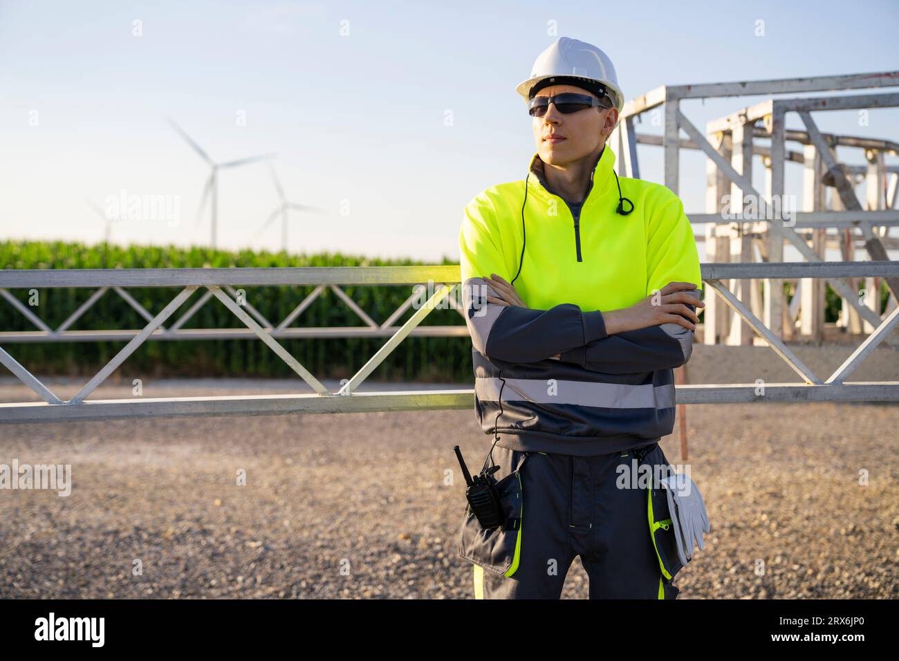 Engineer with arms crossed standing in front of clear sky Stock Photo ...