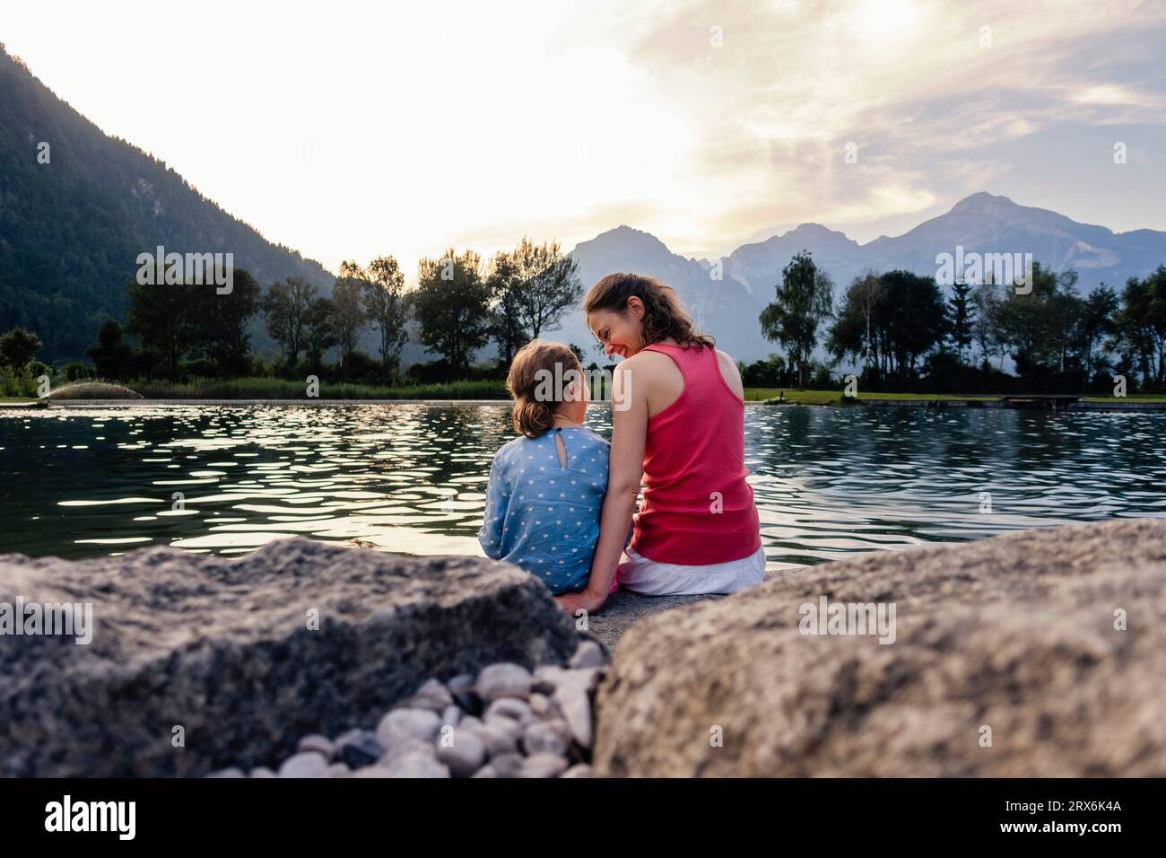 Girl rear view sitting rock hi-res stock photography and images - Alamy