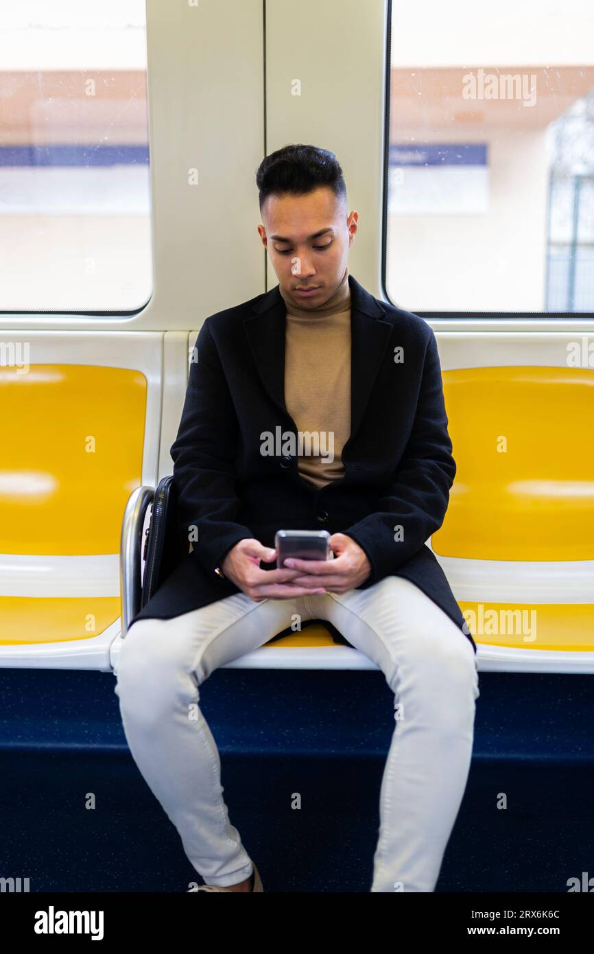 Man texting on train hi-res stock photography and images - Alamy