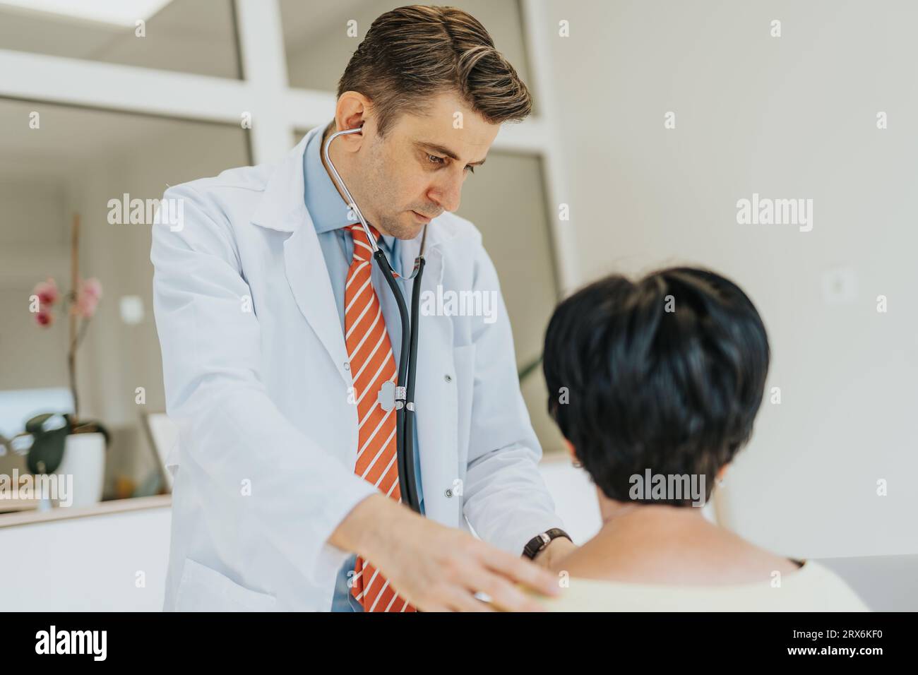 Experienced doctor examines patient, checks vital signs, measures blood ...