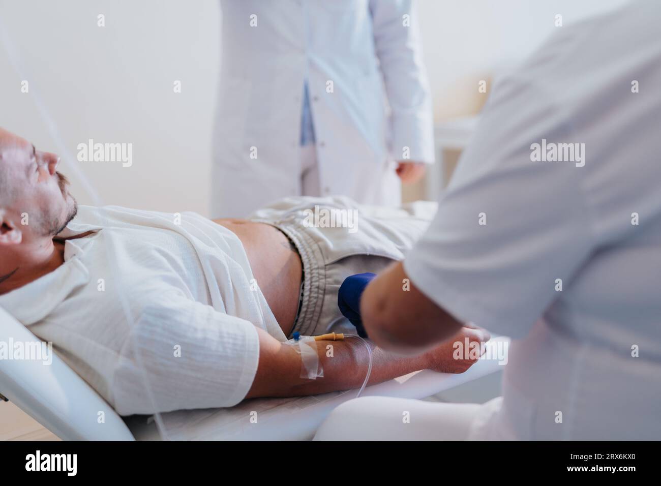 A doctor provides healthcare and medicine, administering infusion ...