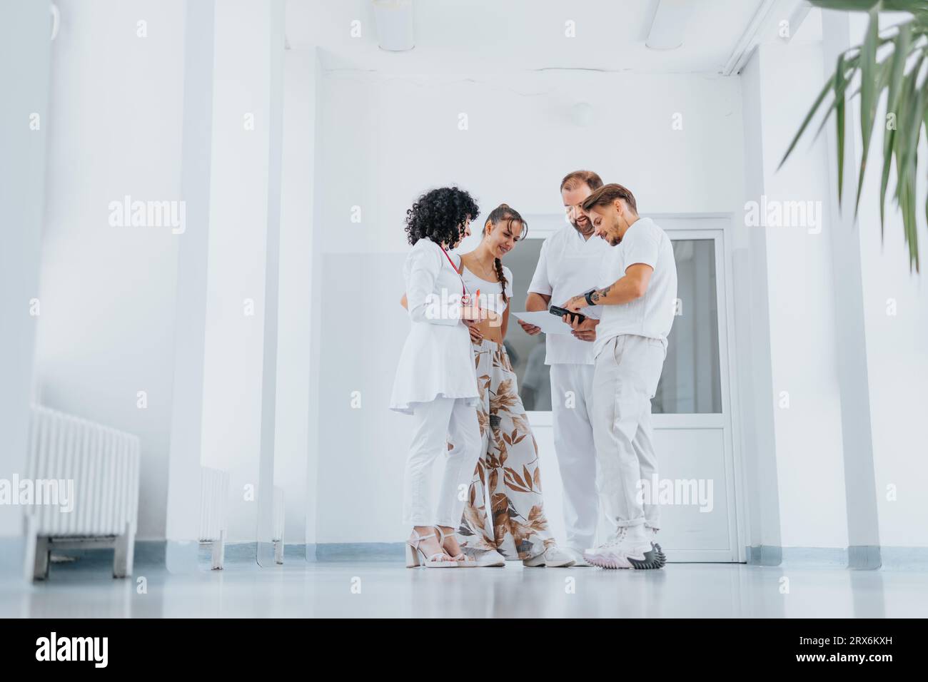 Experienced healthcare professionals consulting patients in a busy ...