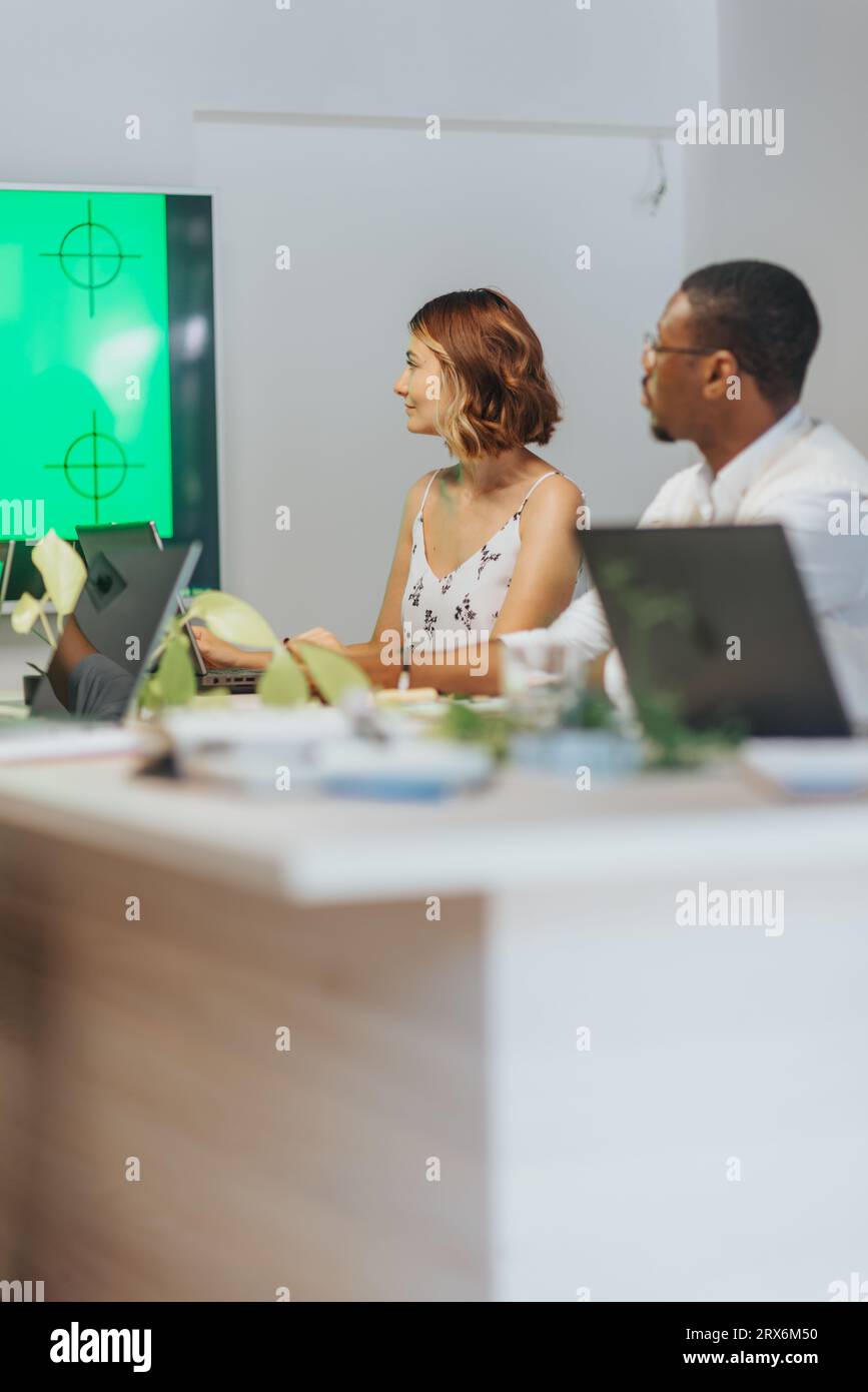 Business partners collaborating in a modern conference room, discussing ...