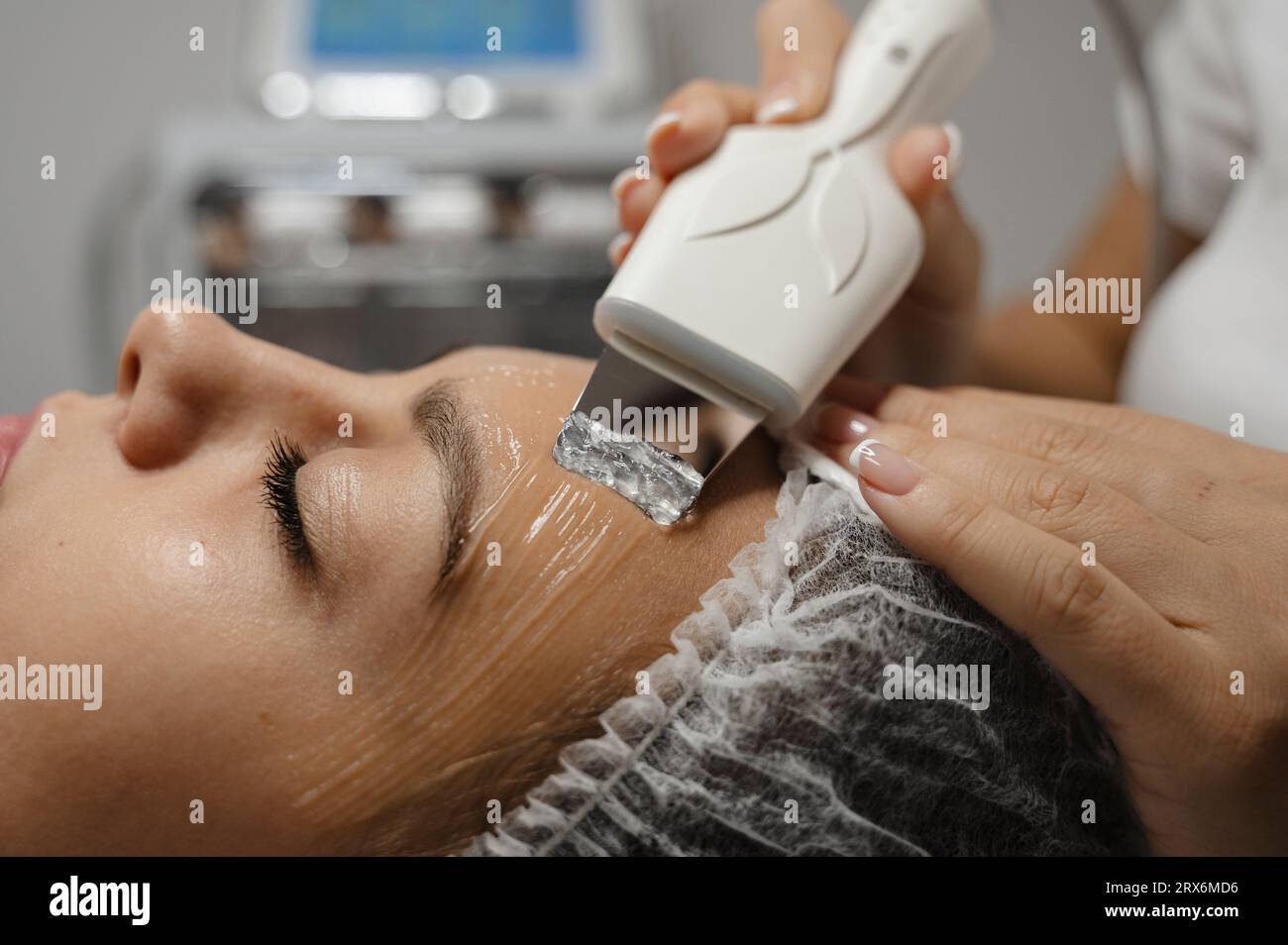 Dermatologist doing ultrasonic facial cleansing on woman's face Stock ...