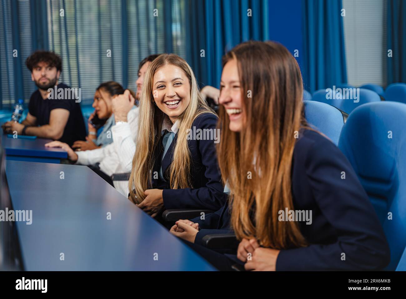 Happy, overjoyed students laughing while attending classes at ...