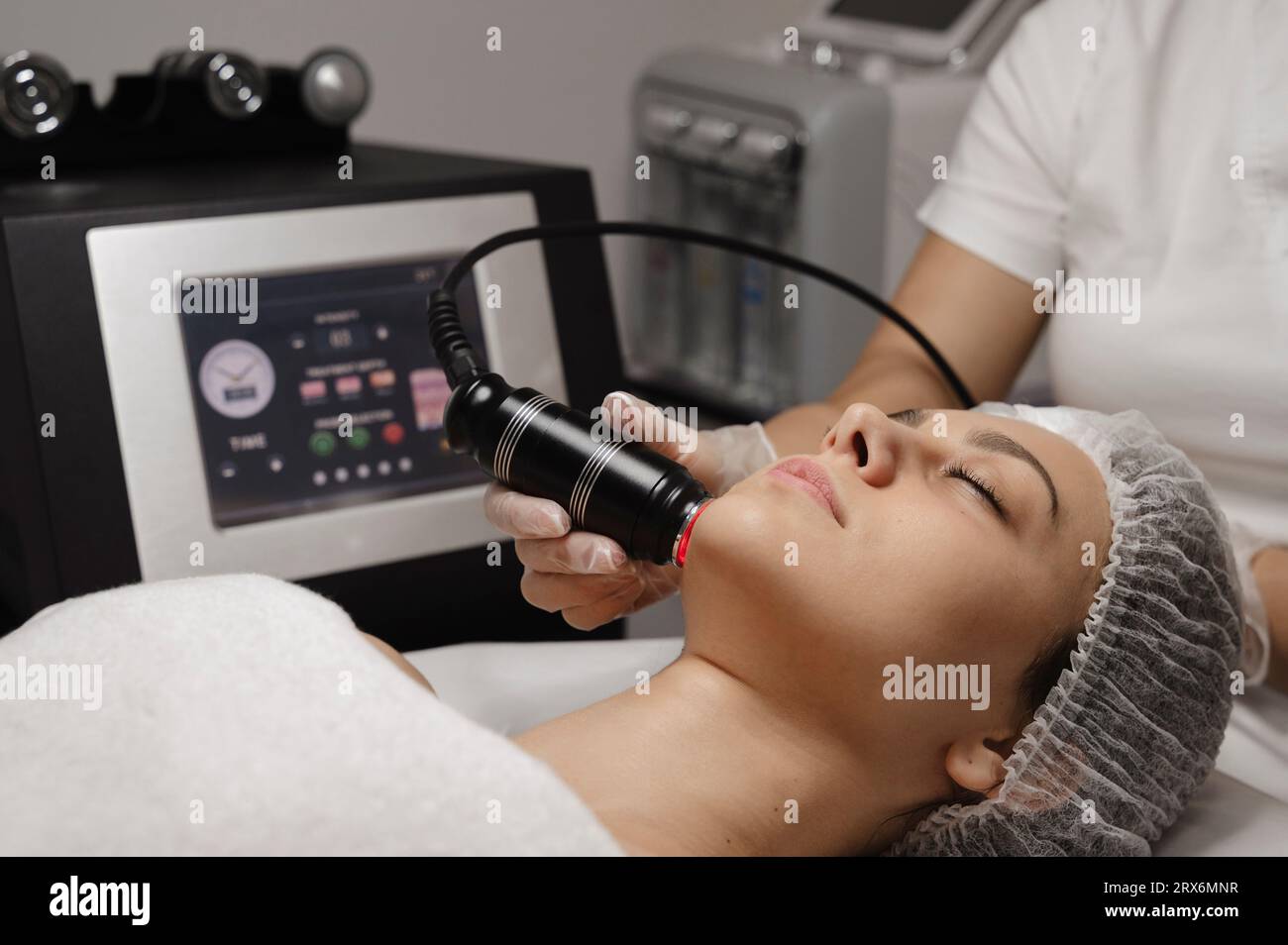 Dermatologist doing Rf lifting procedure on woman's face Stock Photo ...