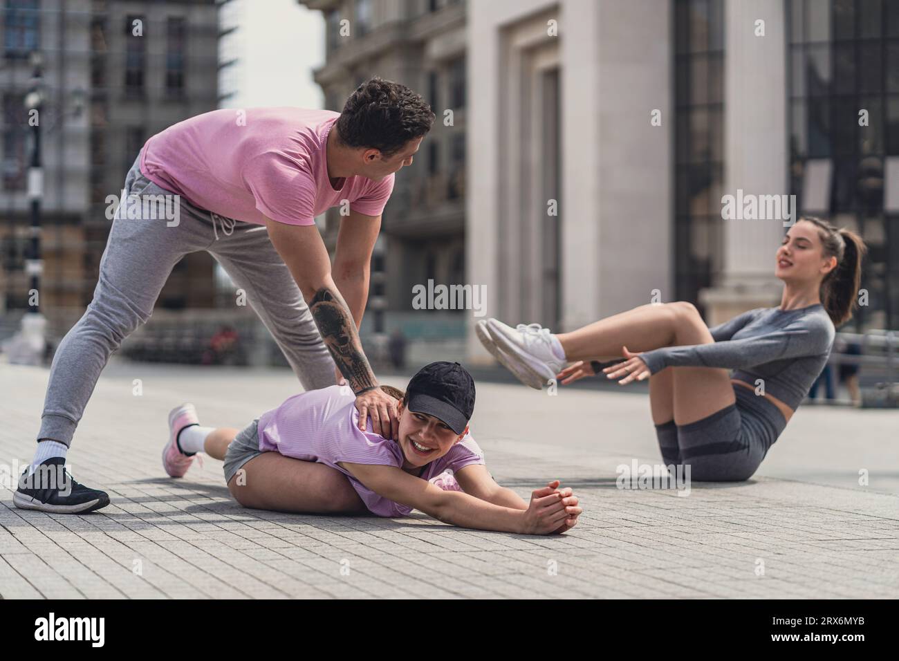 Sportsman having a conversation with his brunette friend while pushing ...