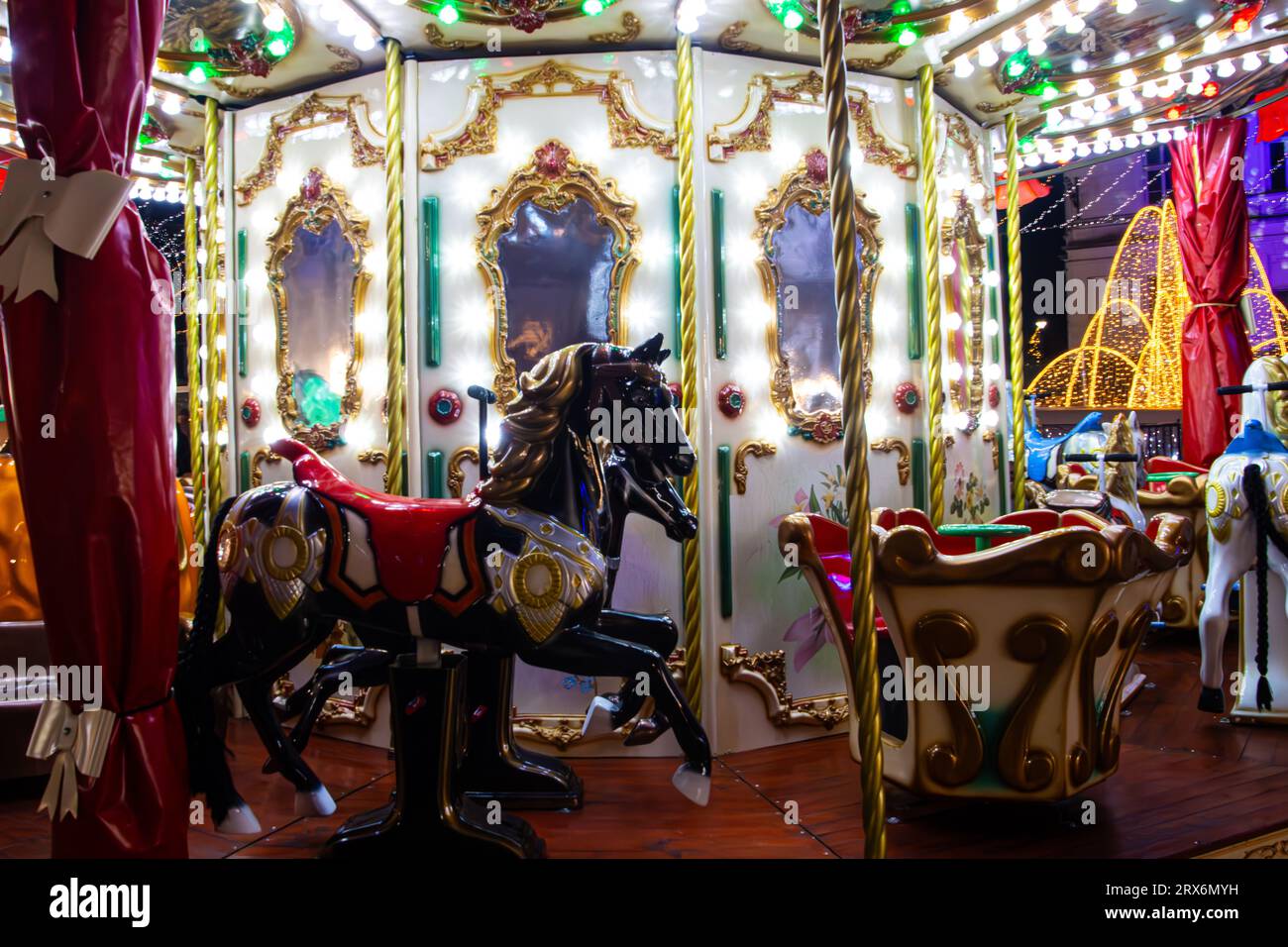 Christmas Carousel .Black carousel horse at the Christmas market in ...