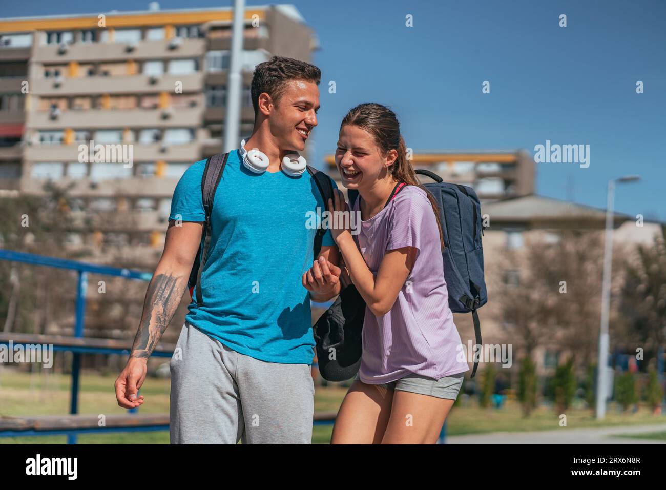 Male sports person joking with his female friend. She is laughing Stock ...