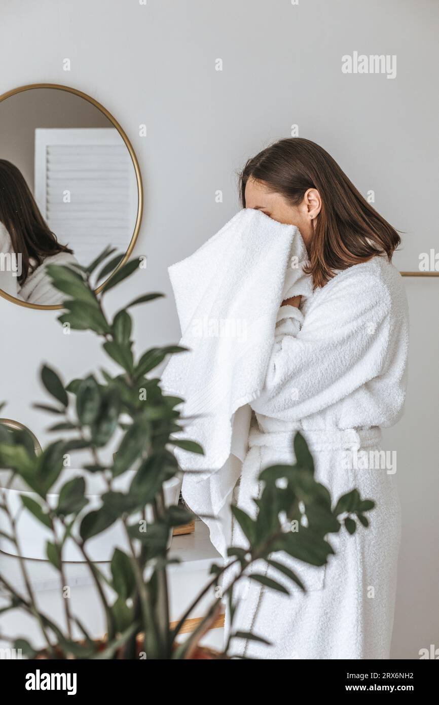 Woman wiping face with towel hi-res stock photography and images - Alamy