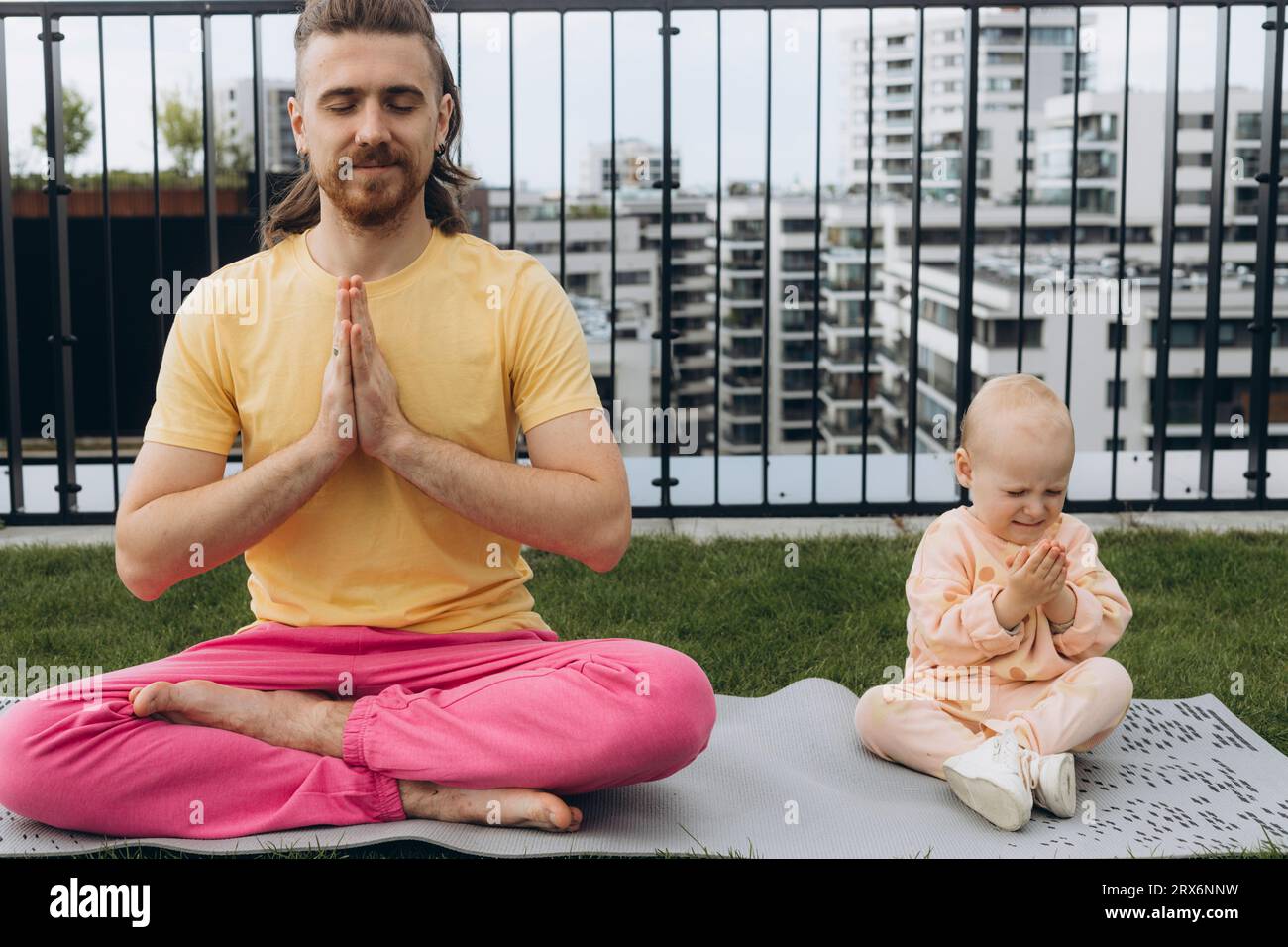 Father and daughter doing prayer pose on rooftop Stock Photo - Alamy