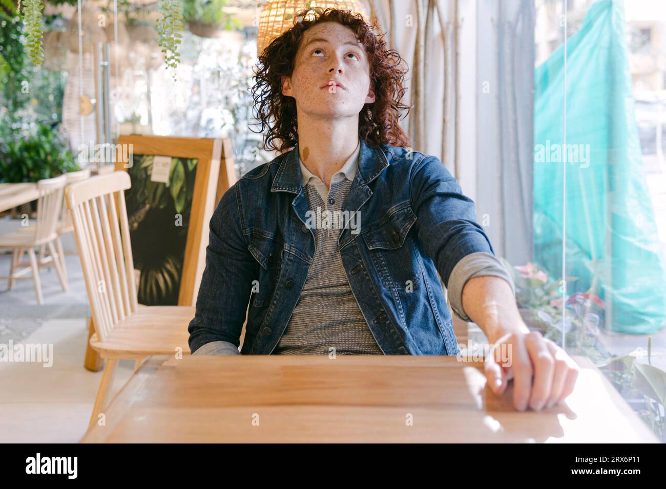 Pensive young man table hi-res stock photography and images - Alamy