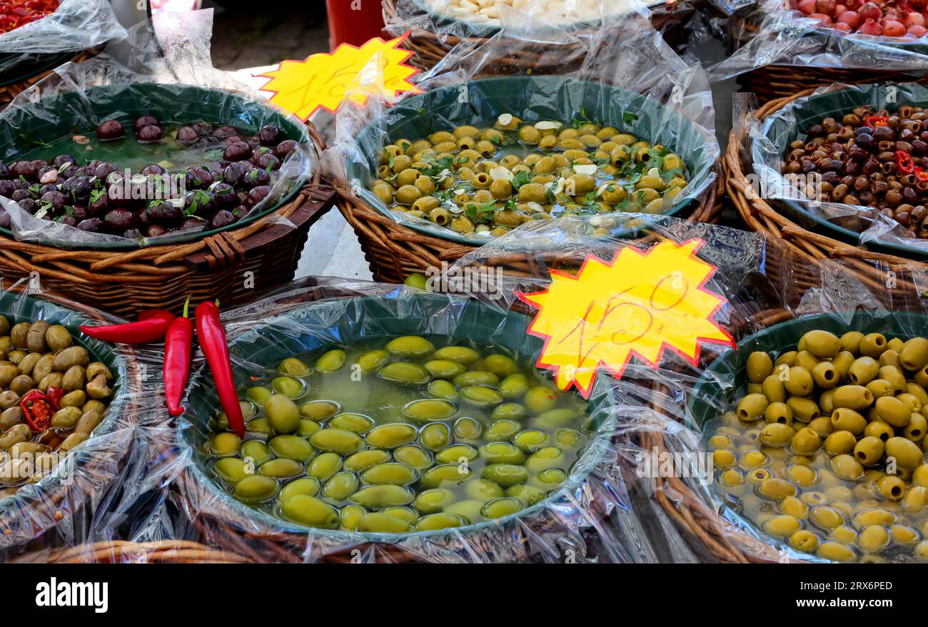 large baskets full of olives of all kinds sizes and colors for sale in ...