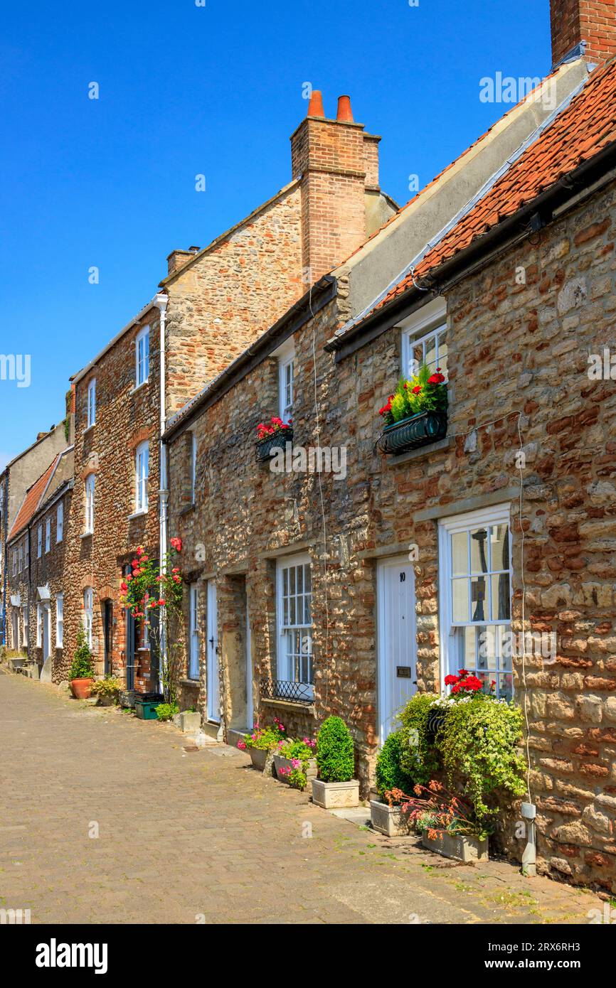 A terrace of attractive stone cottages with colourful floral ...