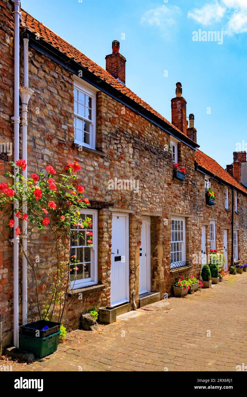 A terrace of attractive stone cottages with colourful floral ...