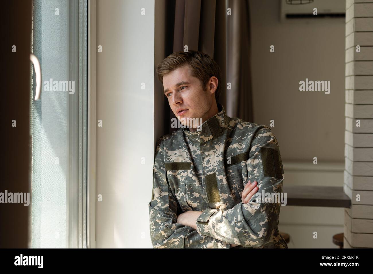 Depressed and sad soldier in green uniform with trauma after war ...