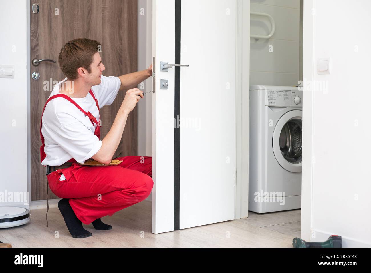 Repair Service Concept. Portrait of smiling handsome young locksmith in ...