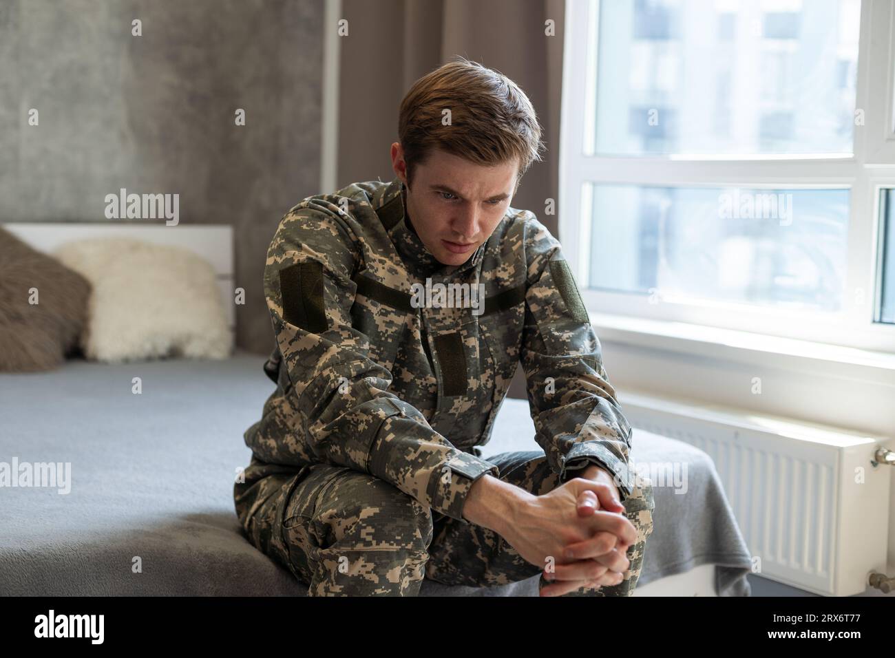 Stressed veteran soldier engrossed in depressive thoughts and memories ...