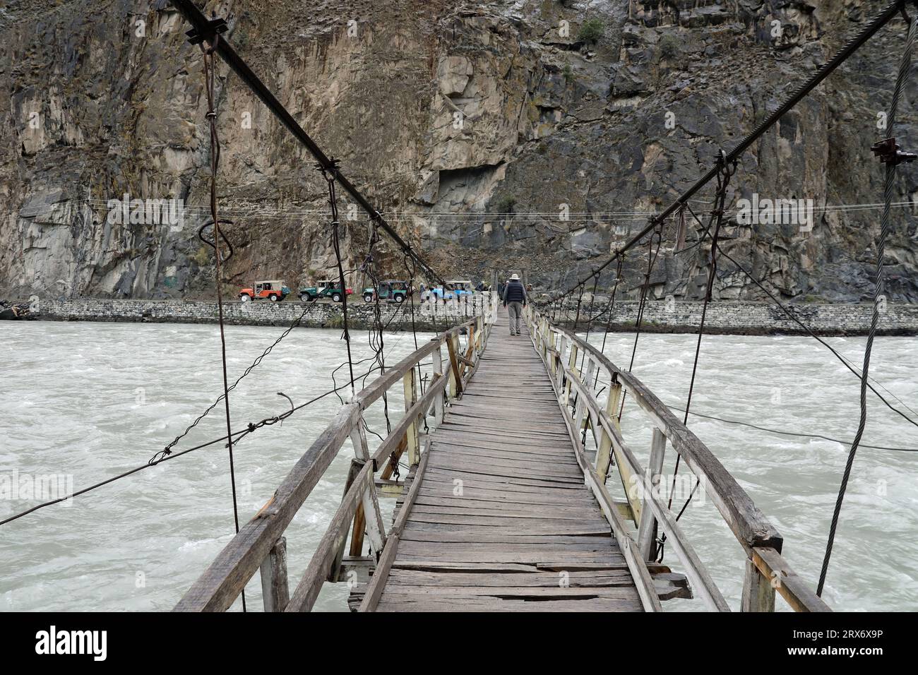 Tourists crossing a rickety wooden bridge in northern Pakistan Stock ...