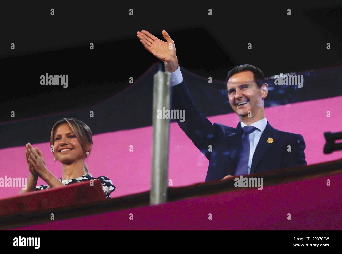 Syrian President Bashar al-Assad (R) attends the opening ceremony of ...