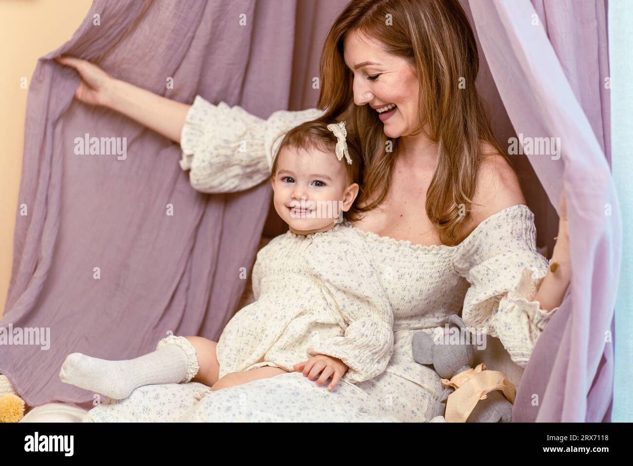 Young mom having loving time with her baby daughter Stock Photo - Alamy