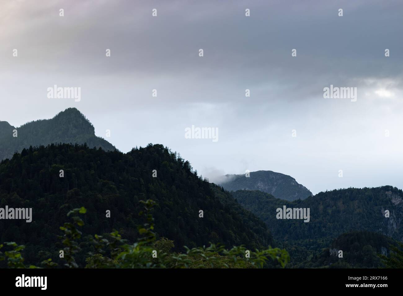 Mountain range in the Bavarian Alps with low clouds in between. The ...