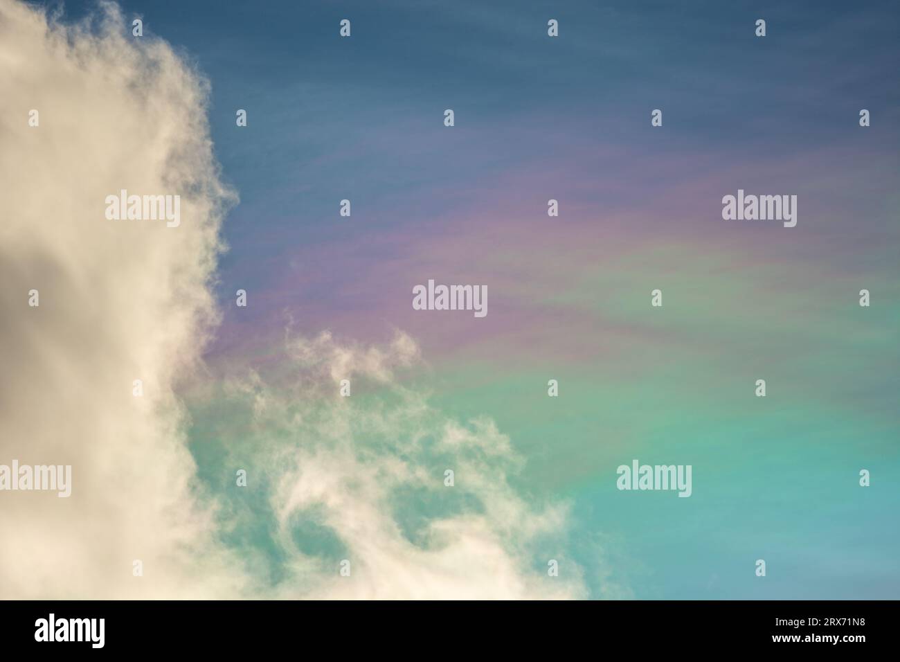 Quite rare optical phenomenon of iridescence of clouds of pearly, pink, green hues with pastel ...