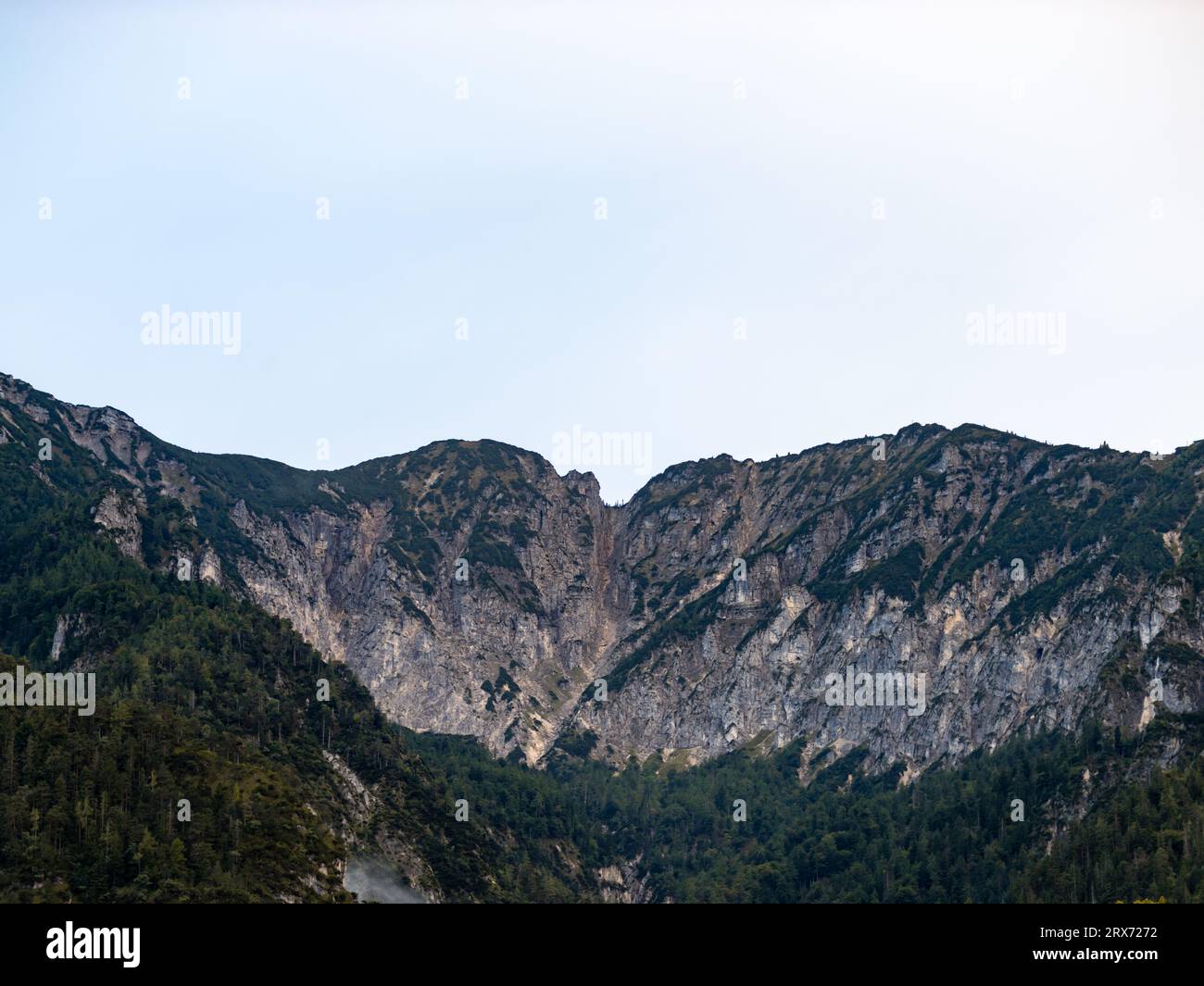 Mudslide in the alpine mountains. Debris and dirt was flowing down in ...