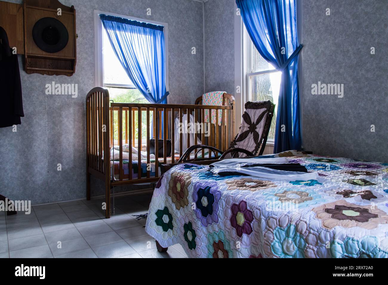 Amish Home interior showing bedroom and wooden baby cot Stock Photo - Alamy