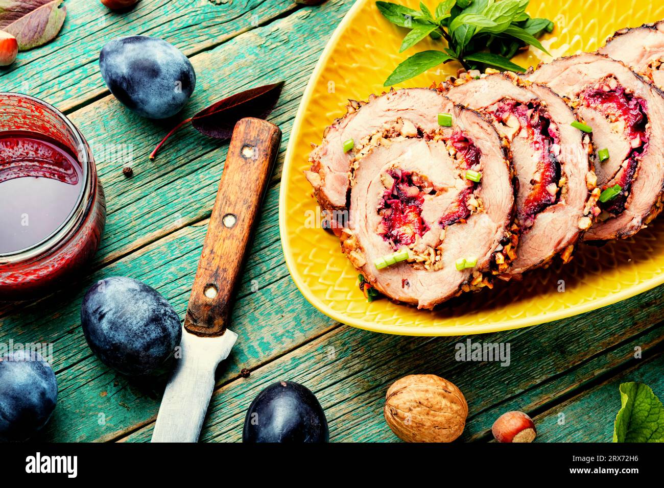 Sliced meatloaf stuffed with plums. Autumn meat recipe. Roast pork with ...