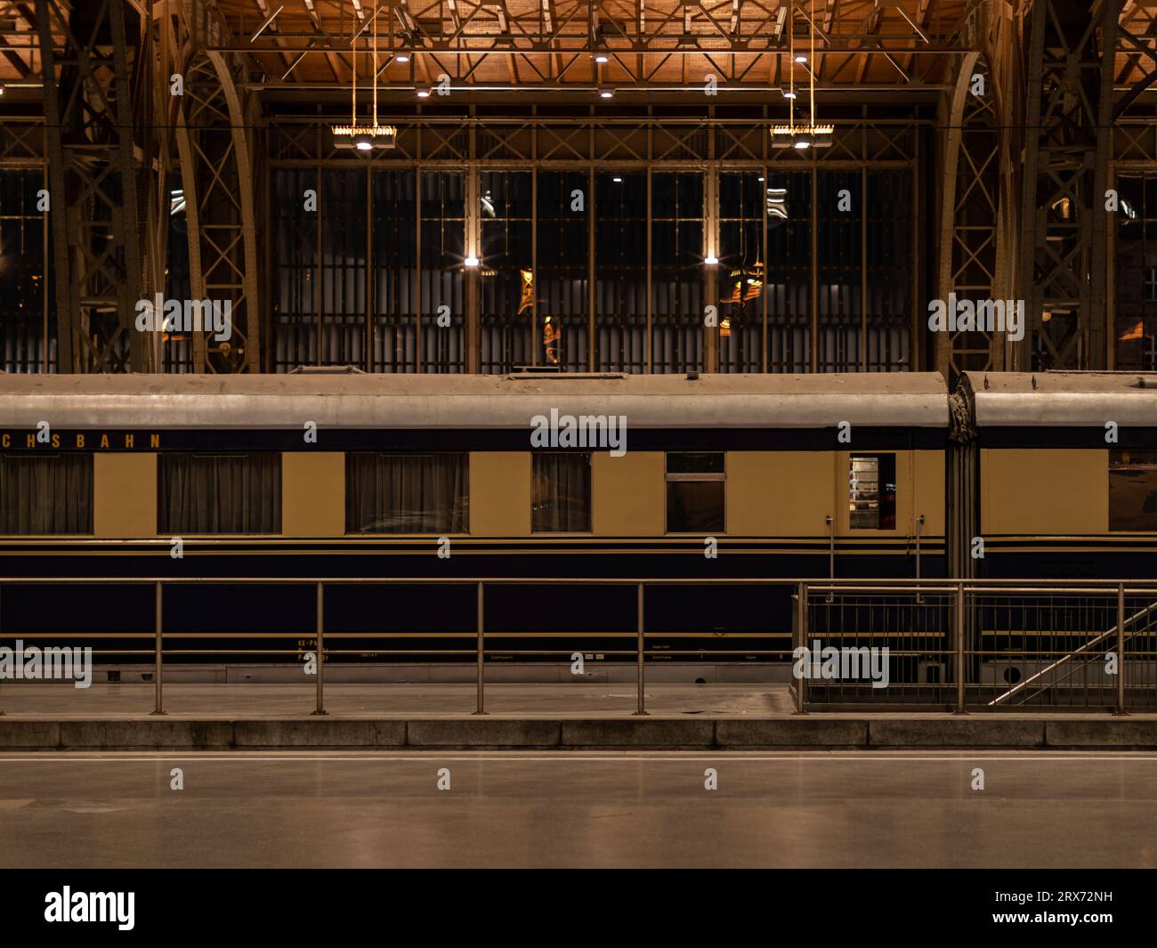 Old train waggon in an illuminated station. Empty platform in a ...