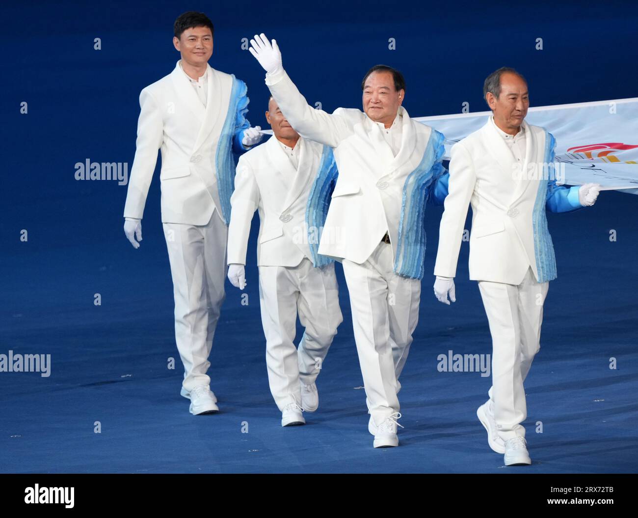 Hangzhou, China's Zhejiang Province. 23rd Sep, 2023. Flag bearer Xu Haifeng (2nd R) waves while ...