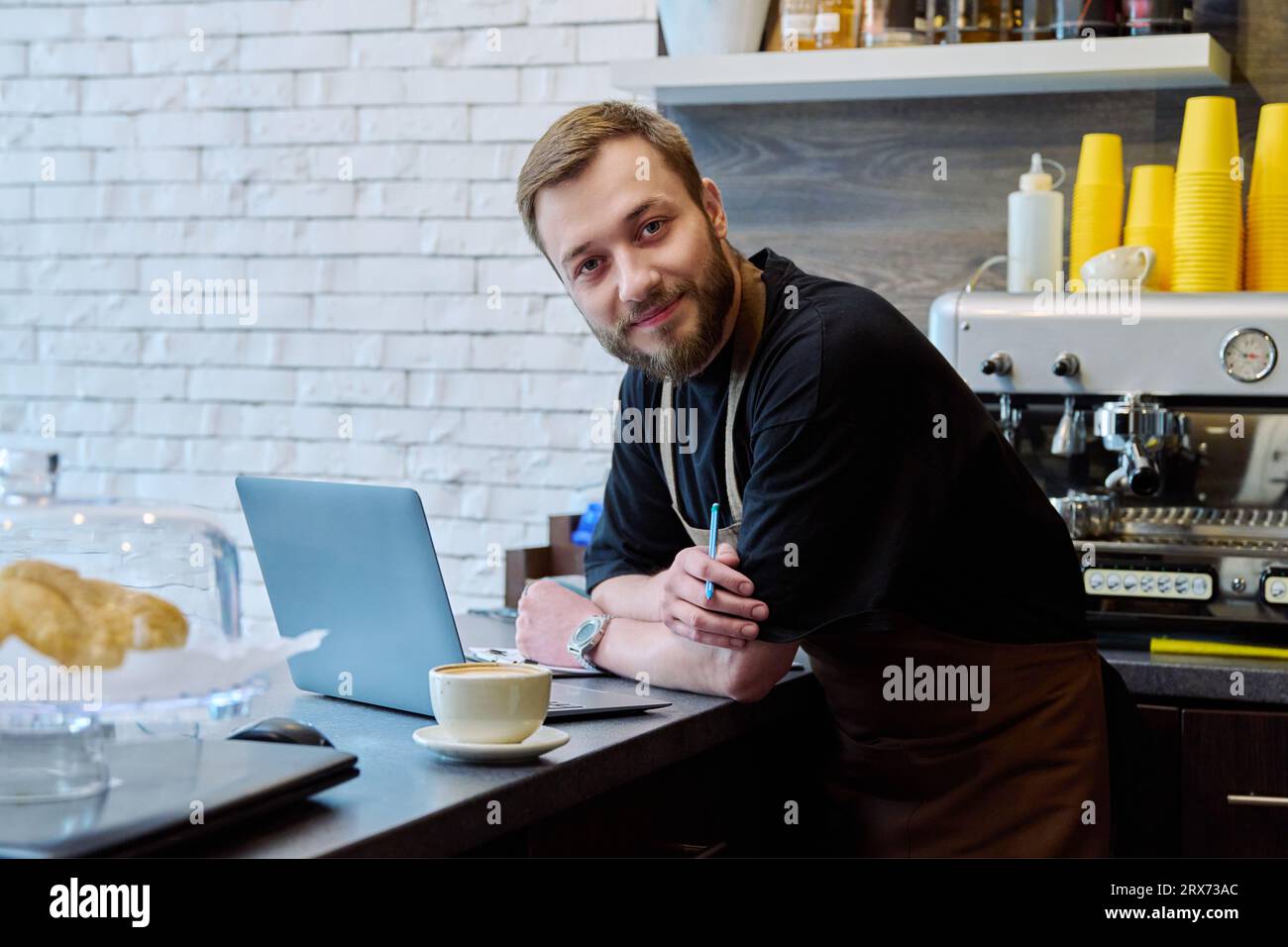 Owner coffee shop worker young male with laptop on the counter Stock ...