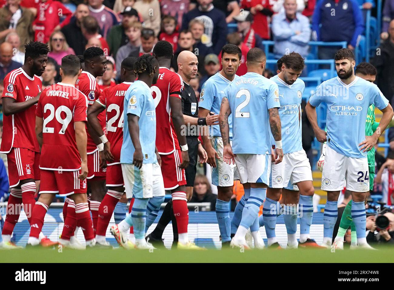 Manchester City's Rodri (centre right) looks dejected after being shown ...
