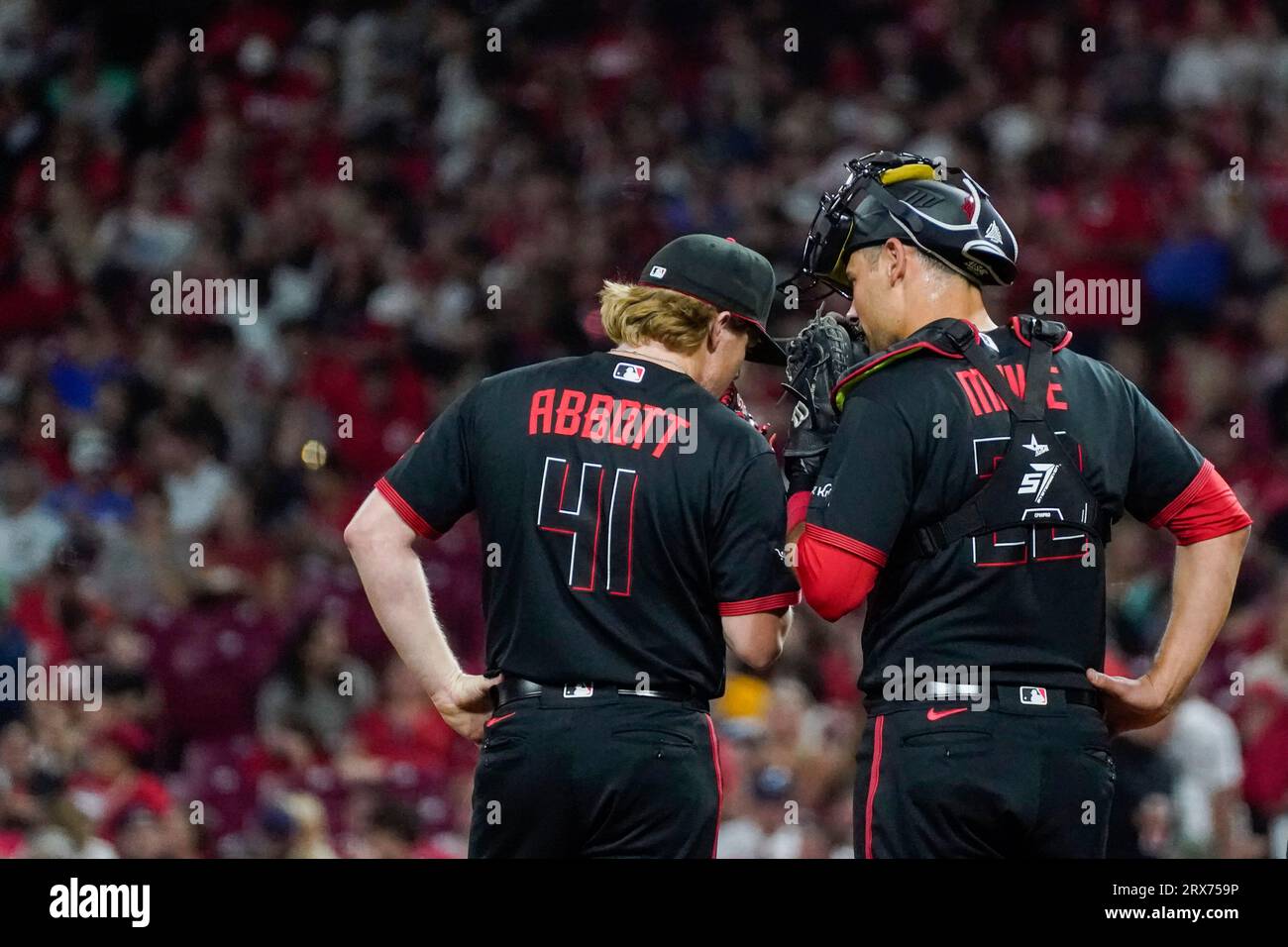 Cincinnati Reds catcher Luke Maile, right, talks with starting pitcher ...