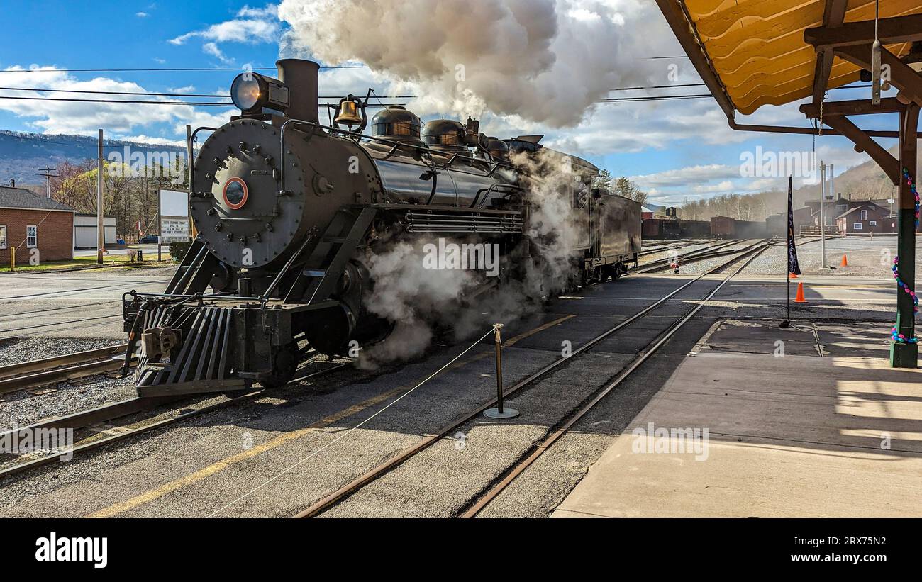 A View of a Restored Narrow Gauge Steam Locomotive Blowing Smoke and ...