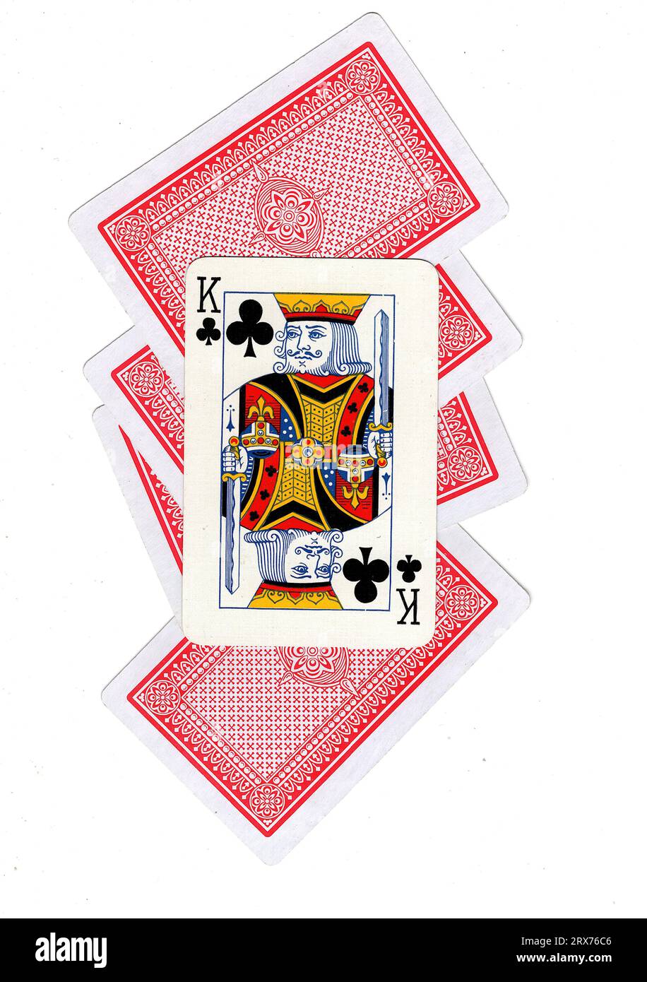 A montage of vintage playing card backs with the king of clubs revealed ...