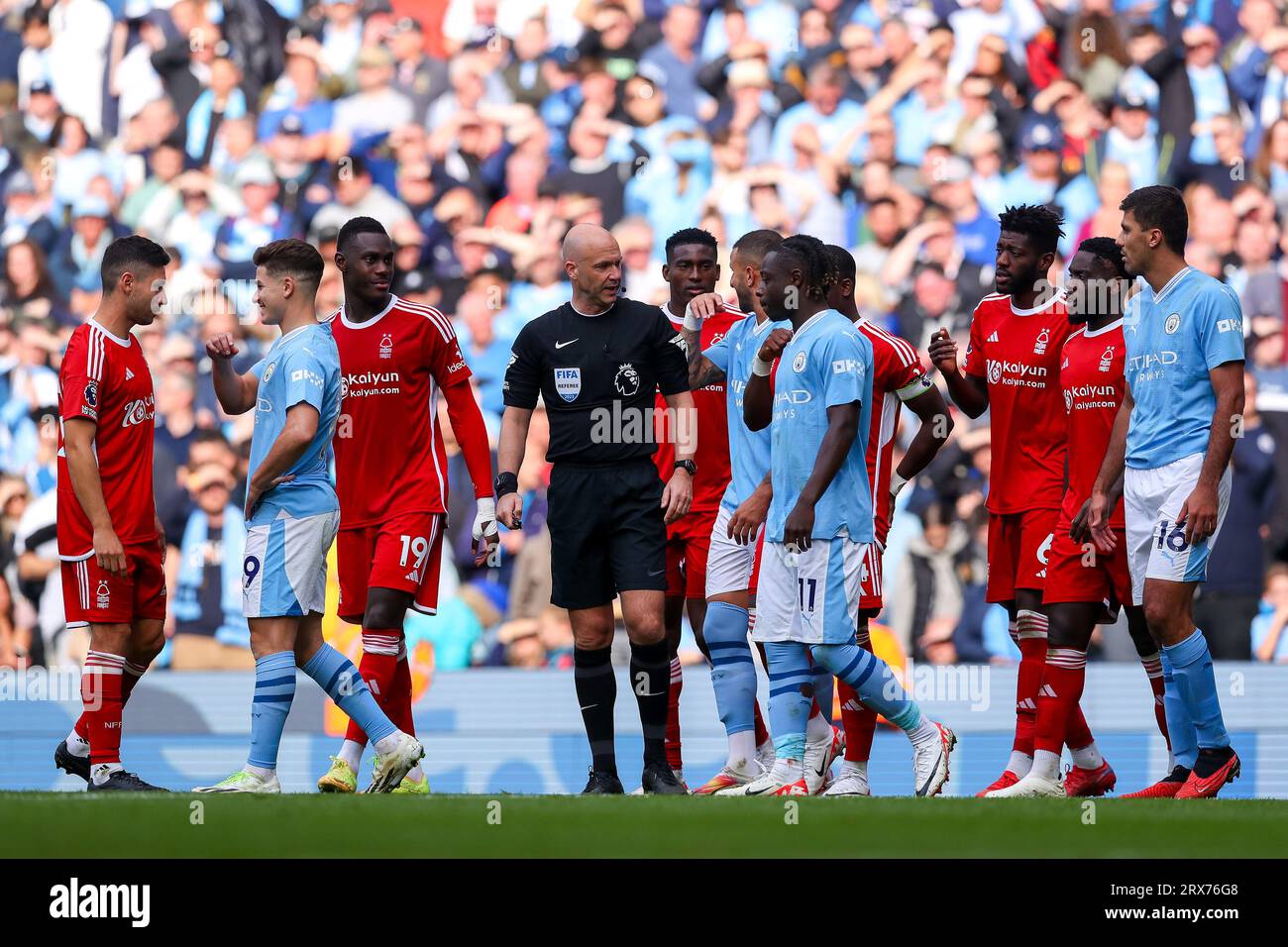 Players surround the referee during a VAR check during the Premier ...