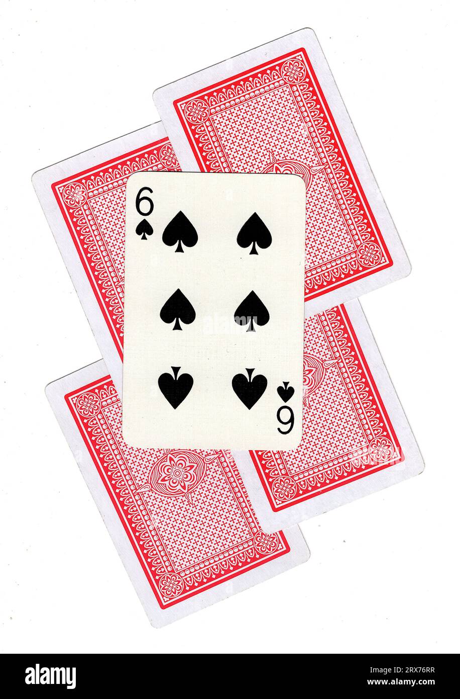 A montage of vintage playing card backs with the six of spades revealed ...