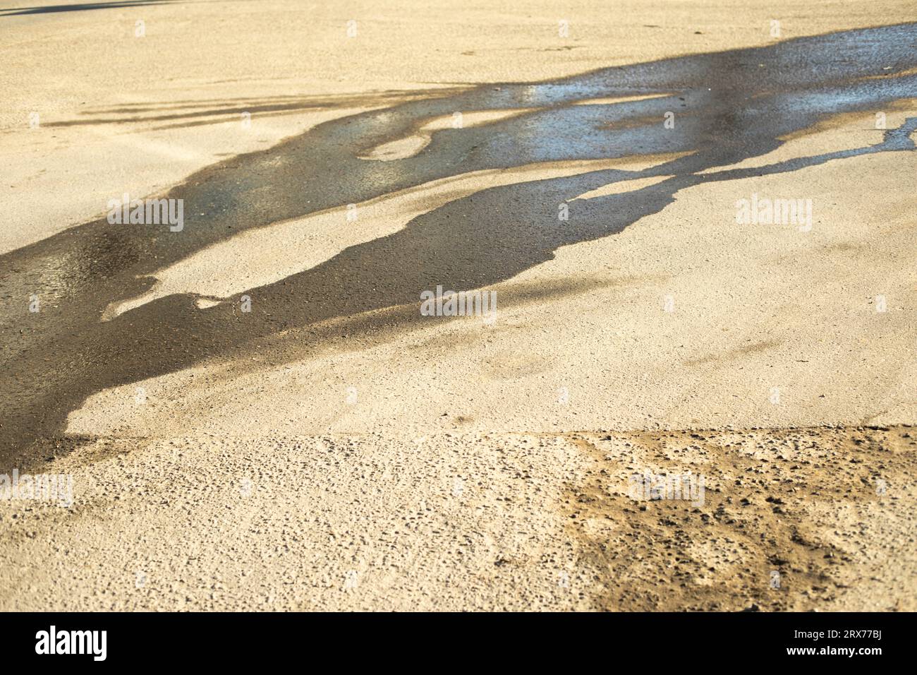 Puddle on pavement. Water on road. Puddle trail. Dirty asphalt Stock ...