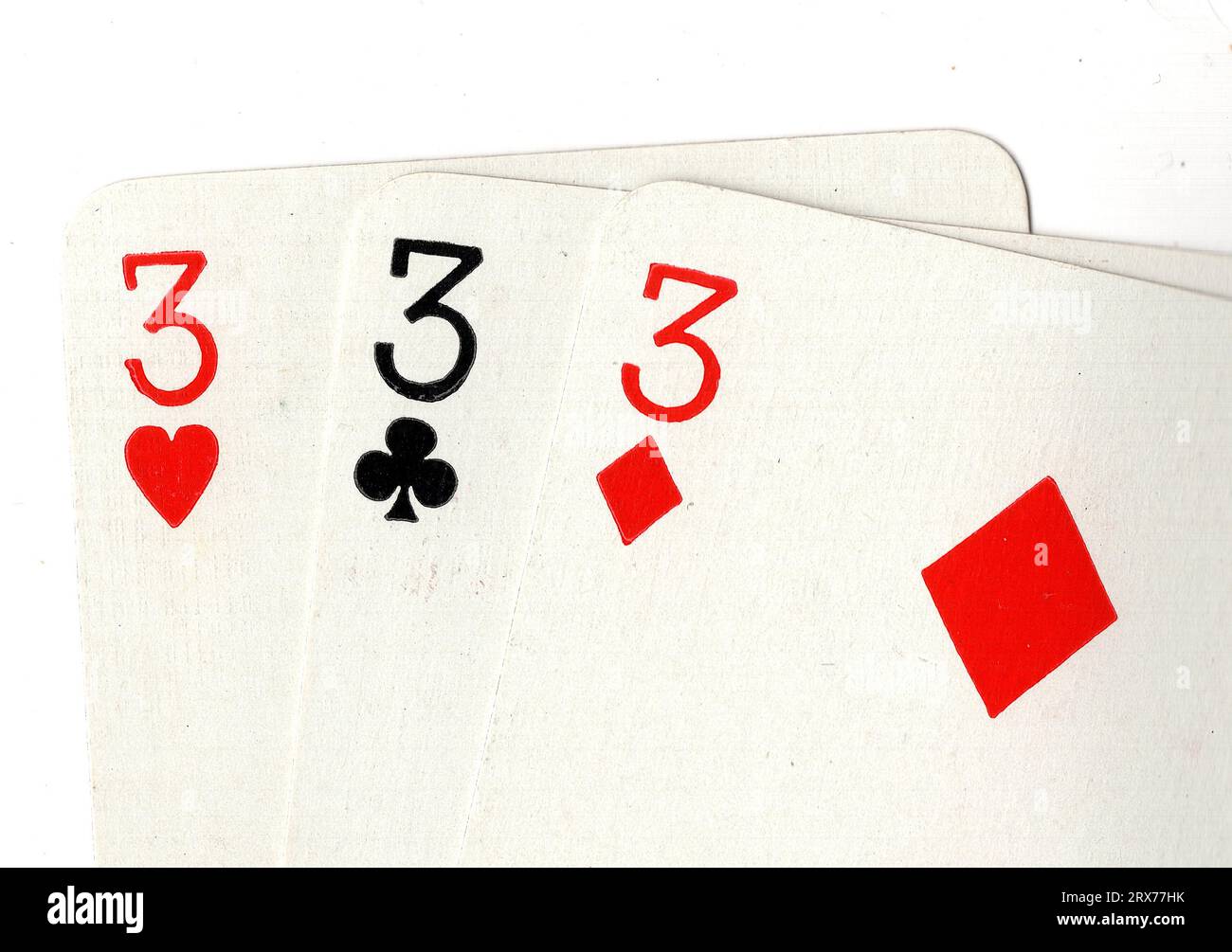 Vintage playing cards showing three threes on a white background Stock ...