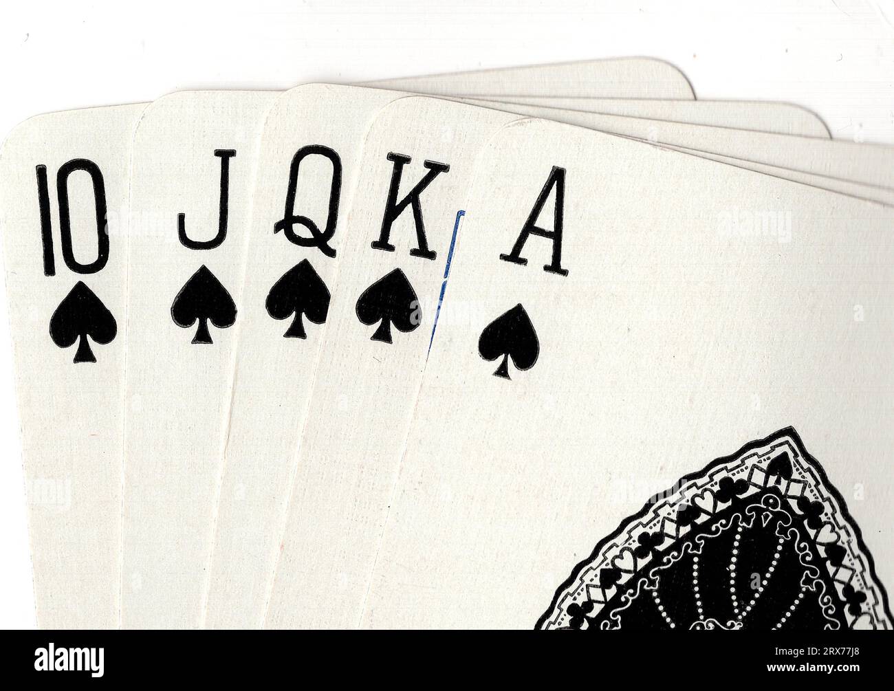 A hand of vintage poker playing cards featuring a royal flush of spades ...
