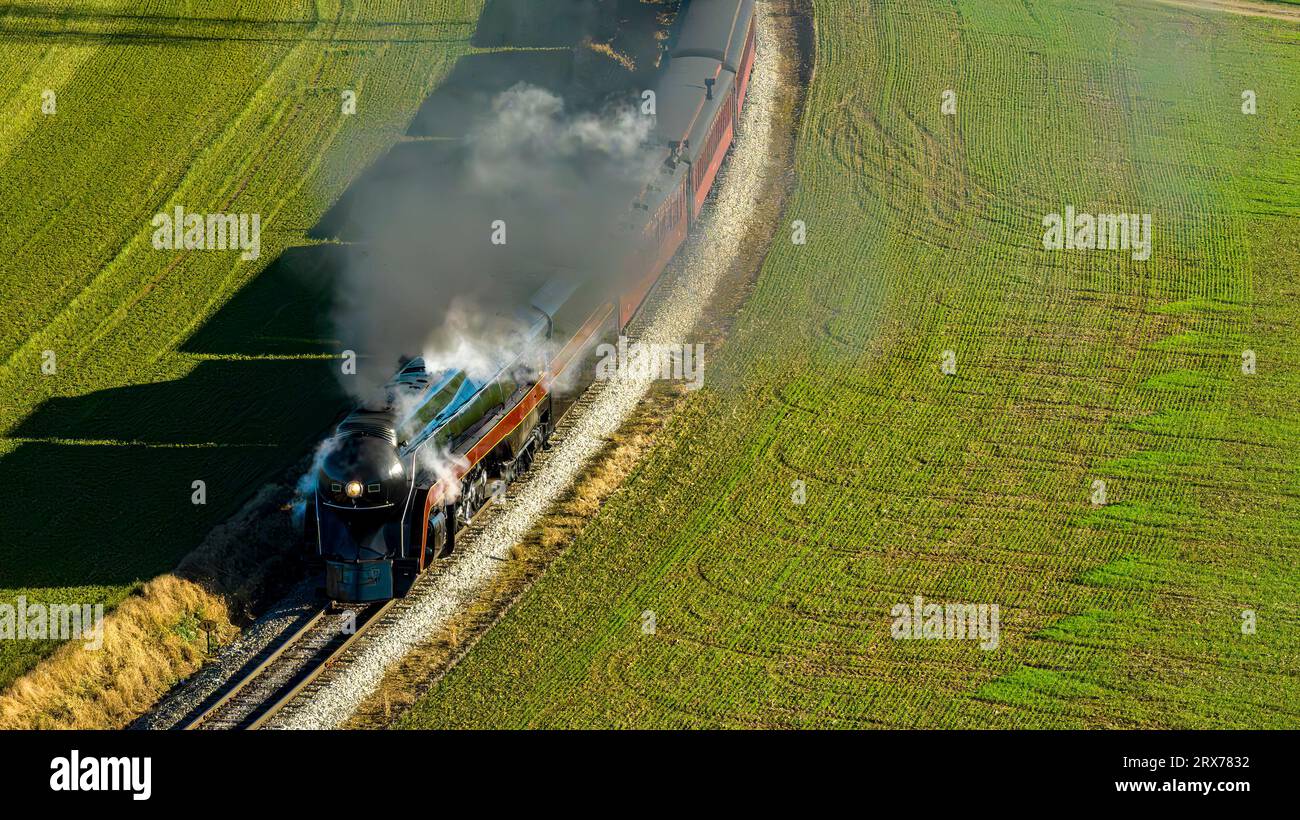 An Aerial View of a Streamlined Steam Passenger Train Traveling Around ...
