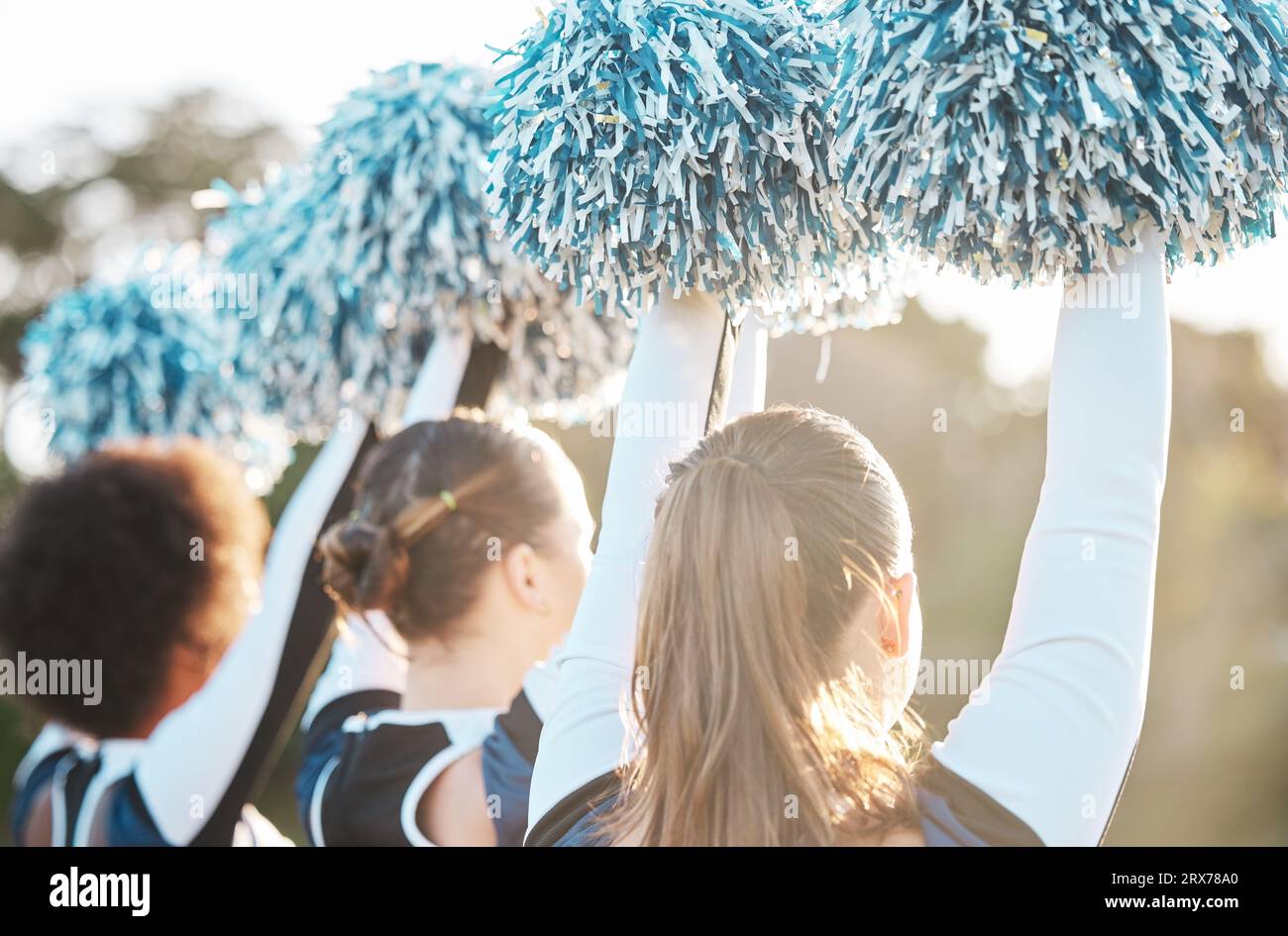 Cheerleader, sports and women with hands raised on field for ...