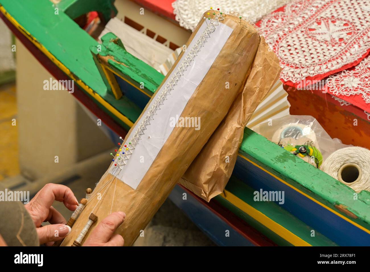 Gozo, Malta - 5 August 2023: Person making souvenir gifts in lace using ...
