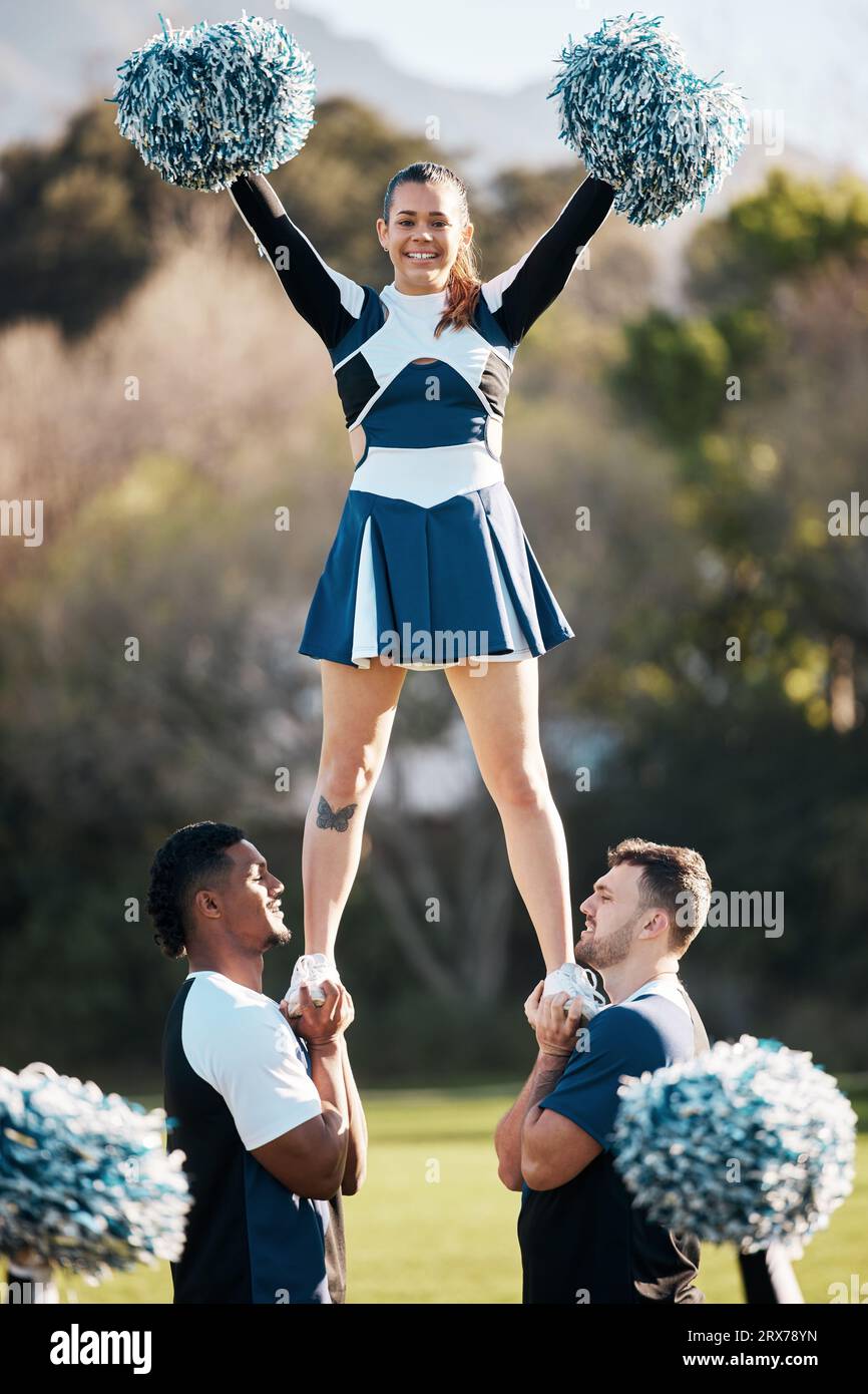 Cheerleader, sports and men balance woman on field for performance ...