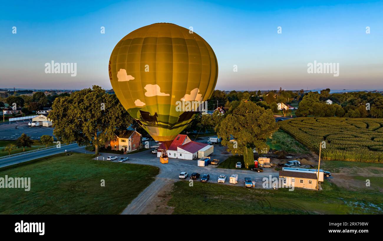 An Aerial View of a Golden Hot Air Balloon, Just Launched and Floating ...